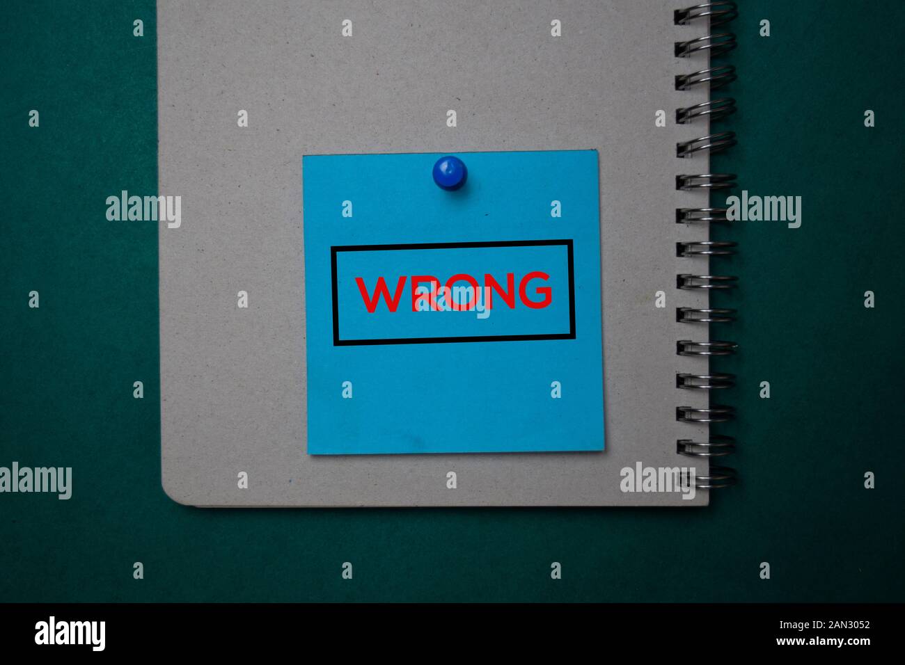 Wrong write on a sticky note isolated on green background Stock Photo ...