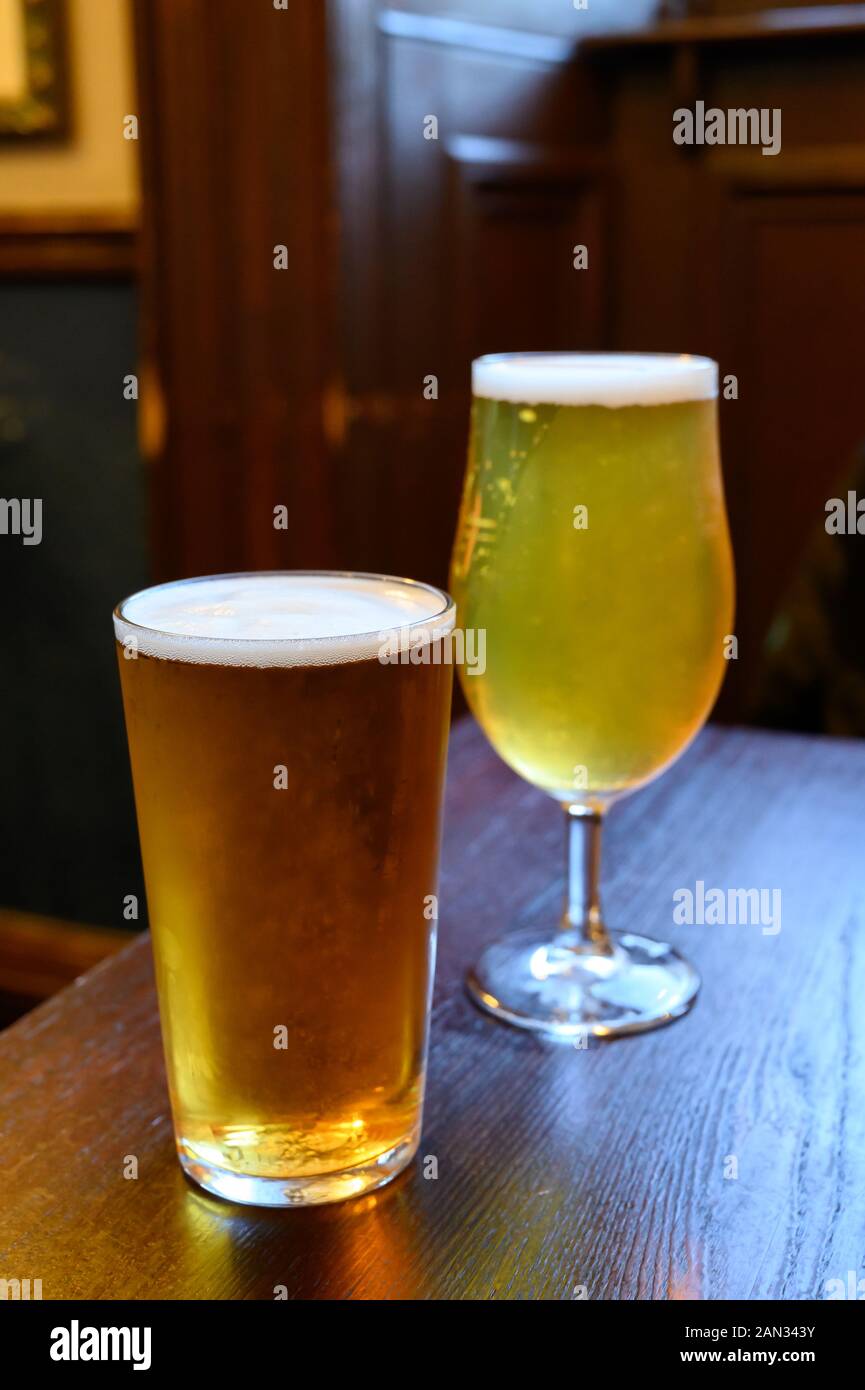 Misty glasses with two pints of cold Scotch ale, amber pale ale, lager ...