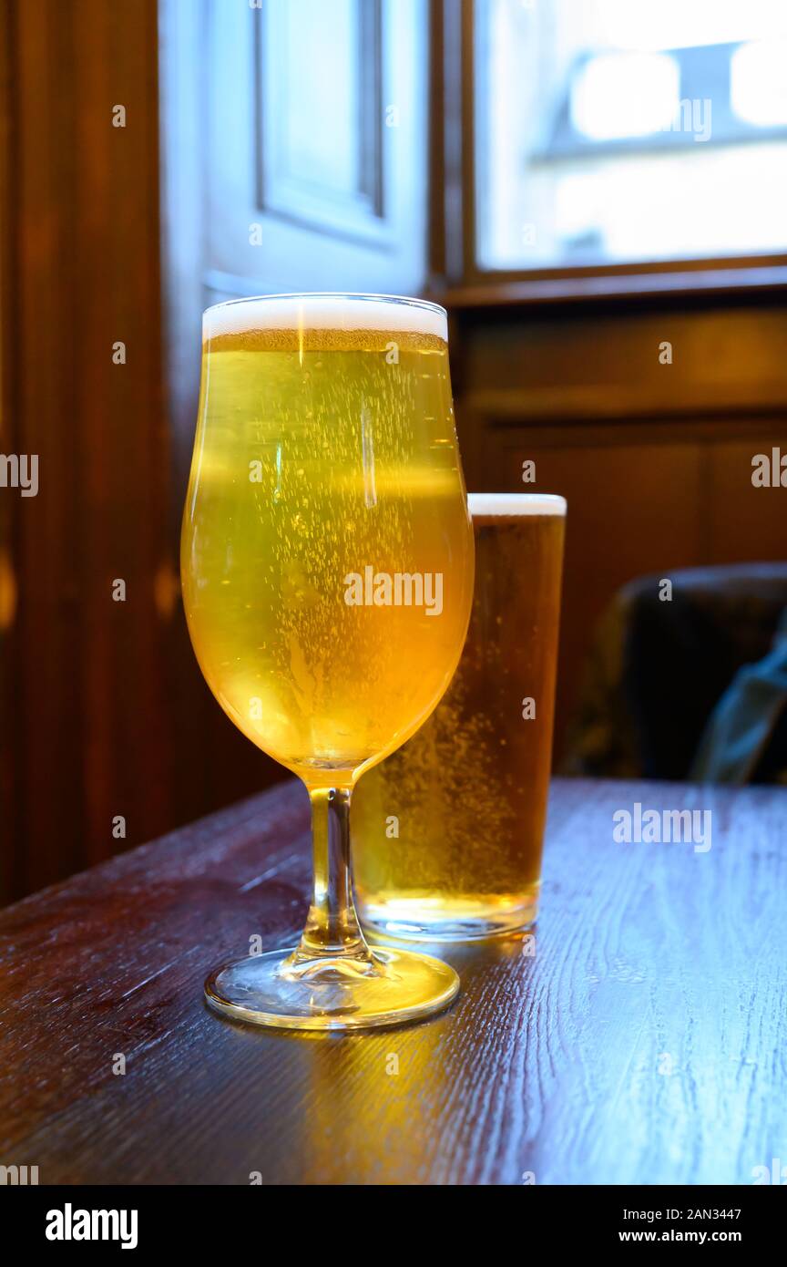 Misty glasses with two pints of cold Scotch ale, amber pale ale, lager ...
