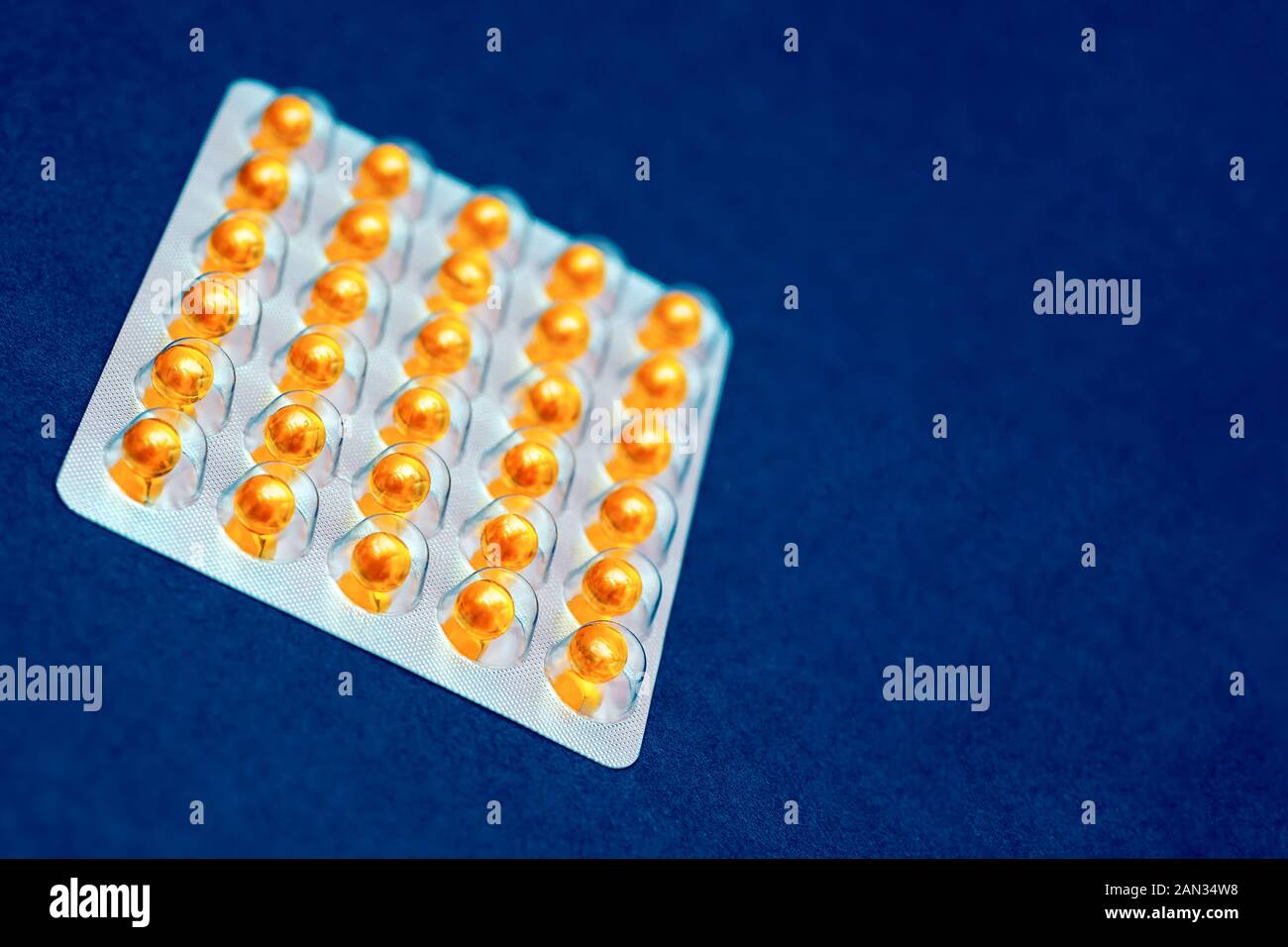 Blister vitamins with fish oil on a blue background Stock Photo - Alamy