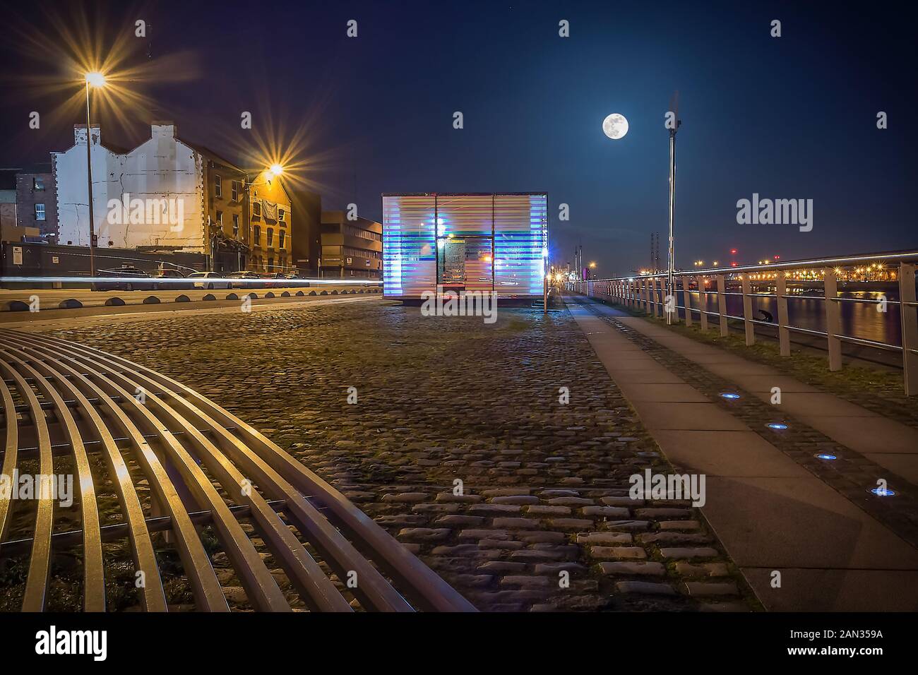 Blue hour at Dublin docks promenade with full moon. Illuminated ...