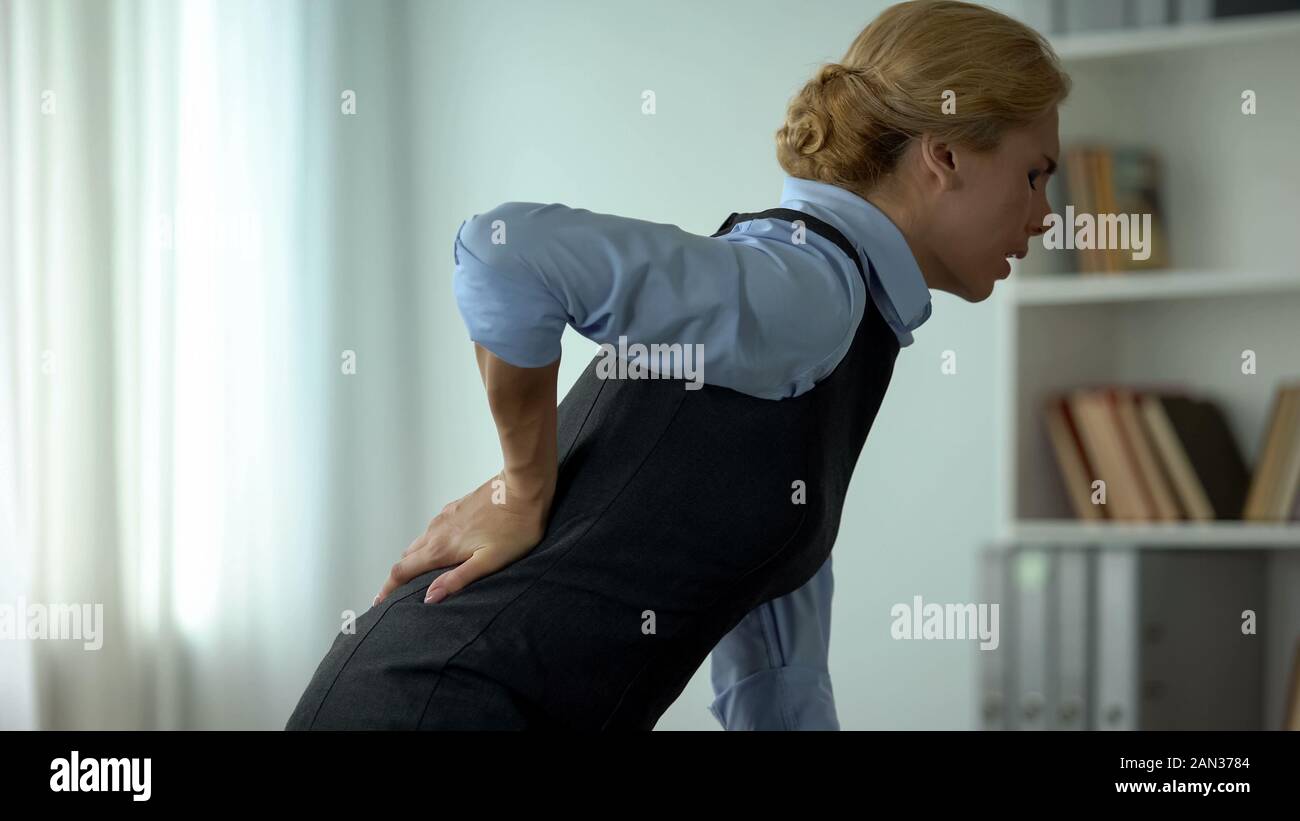Female manager feeling sharp pain in loins, sedentary life on work ...