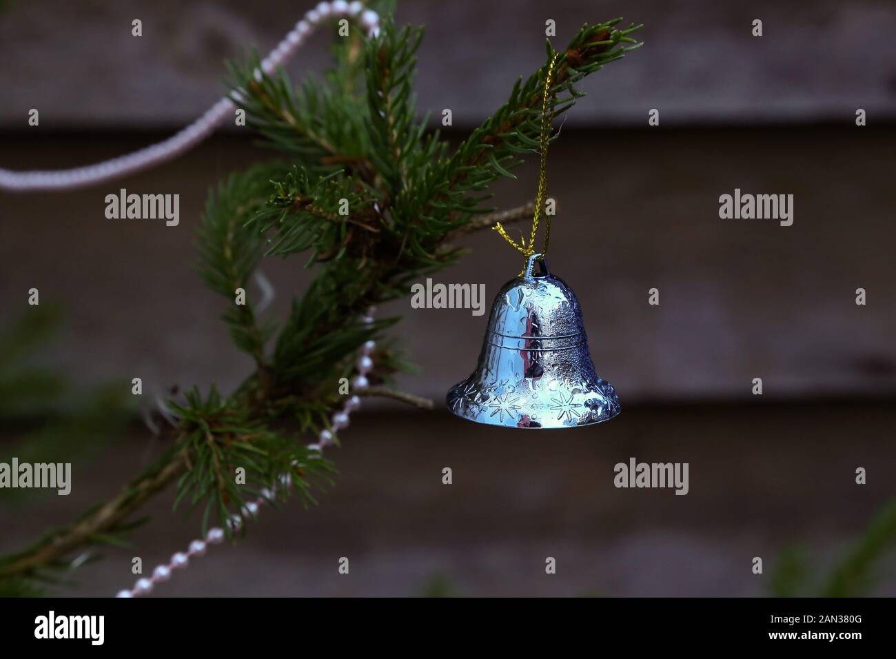 Silver bell hanging on a Christmas tree Stock Photo - Alamy