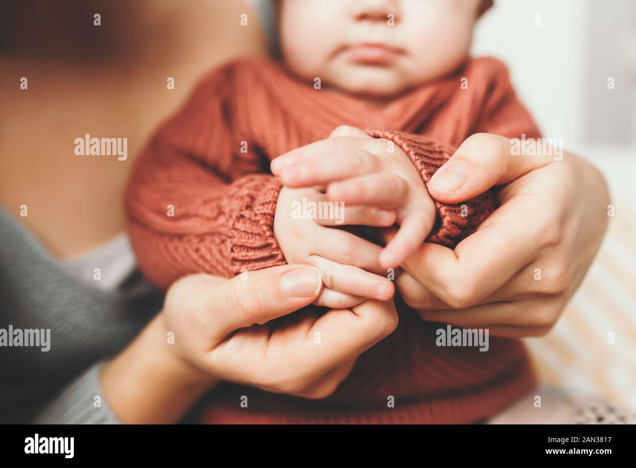 Young mother holding the handles of her little daughter, close-up ...