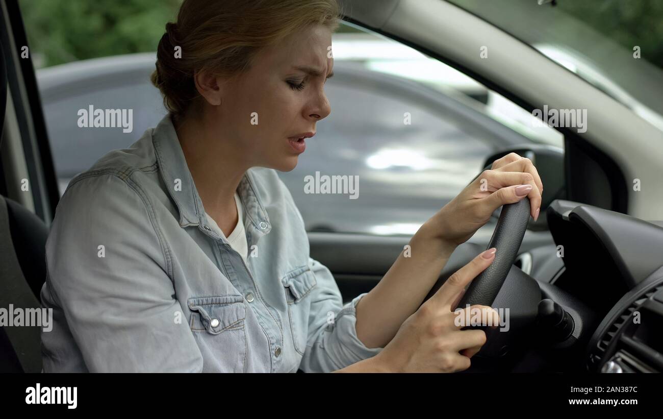 Middle-aged woman driving car suddenly feeling dizziness, risk of faint ...