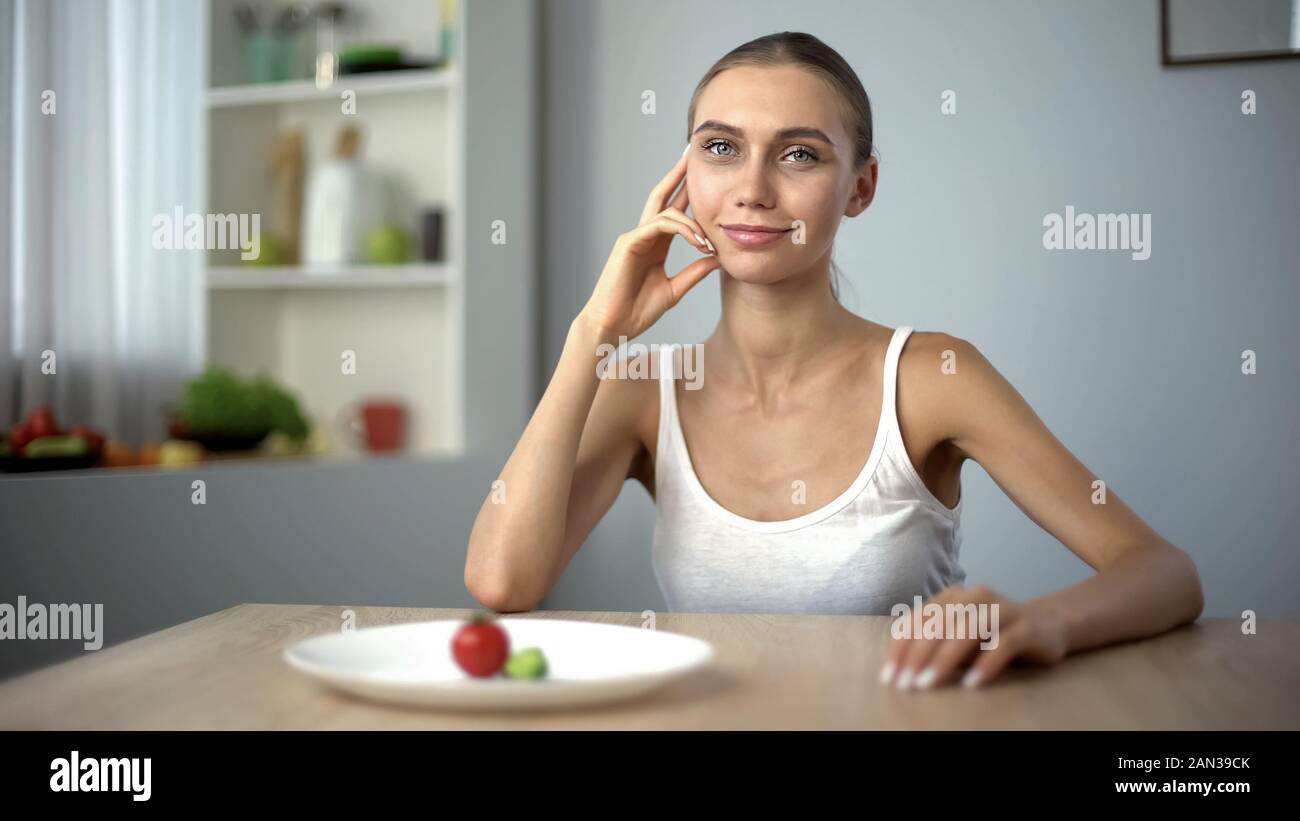 Anorexic girl smiling, conscious choice of severe diet, starving body ...