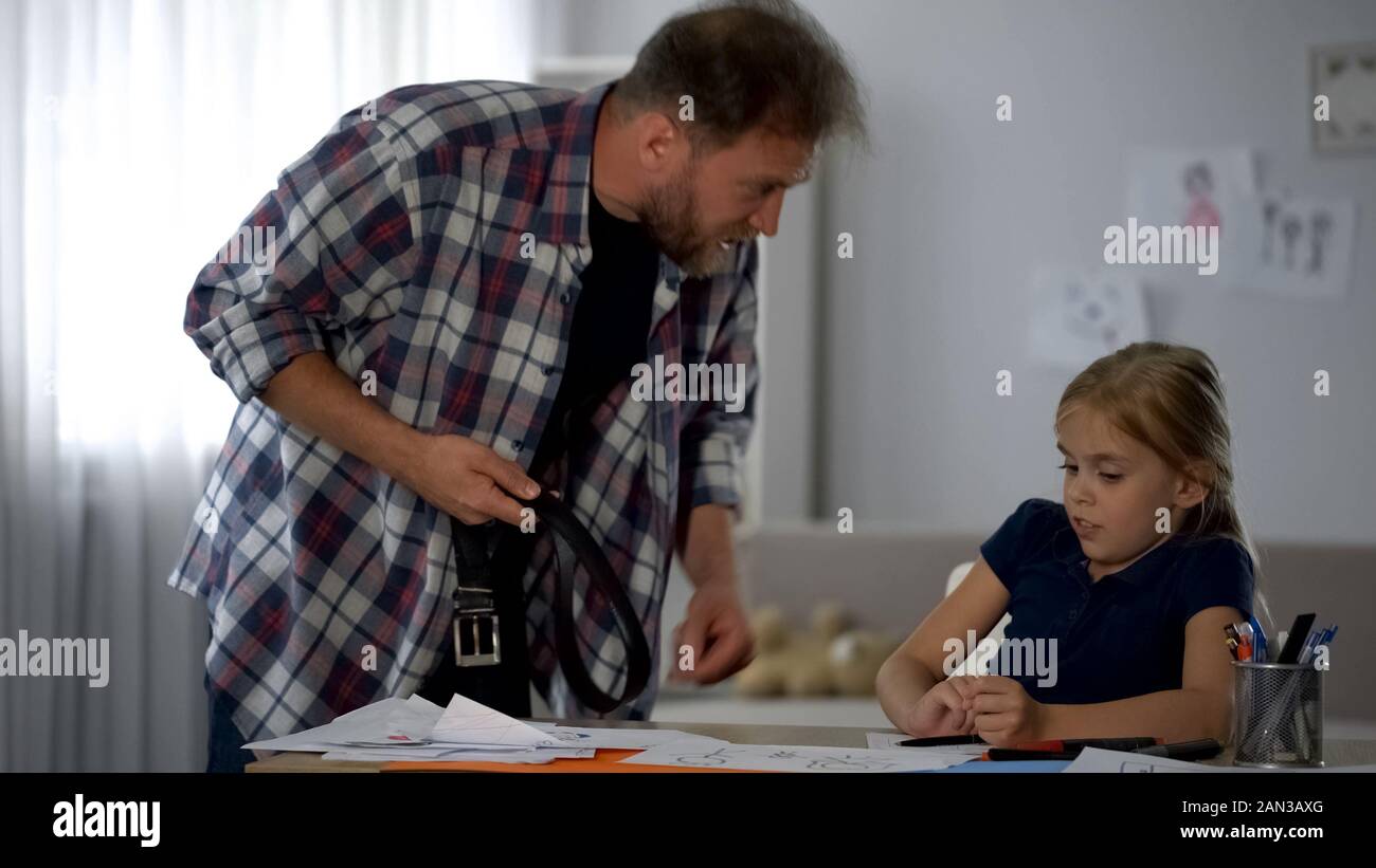 Aggressive dad screaming at daughter, holding strap, punishing for ...