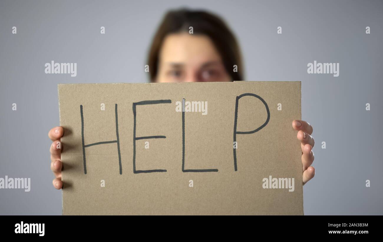 Bruised woman holding help sign, assault in family, violence and ...