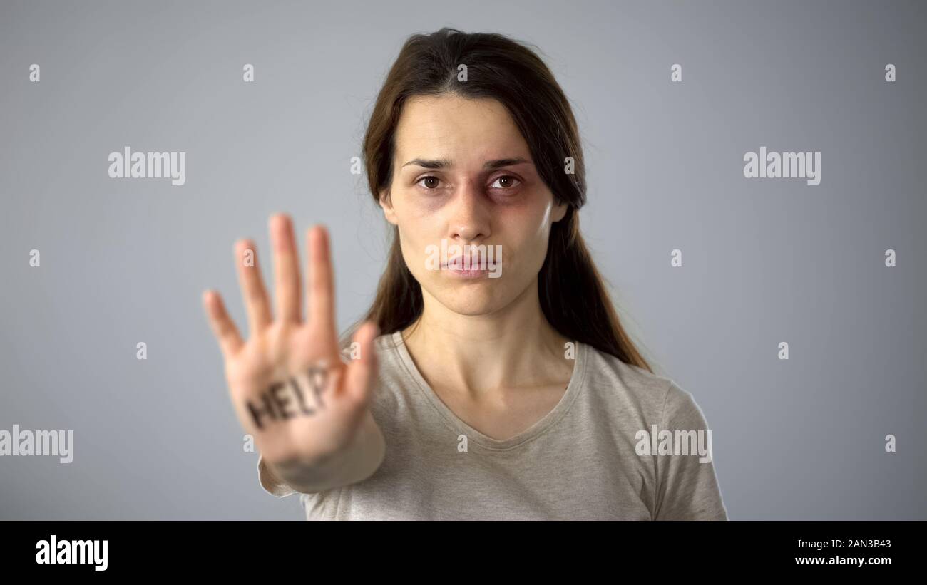 Bruised female with help inscription on hand, assault, cruel treatment ...