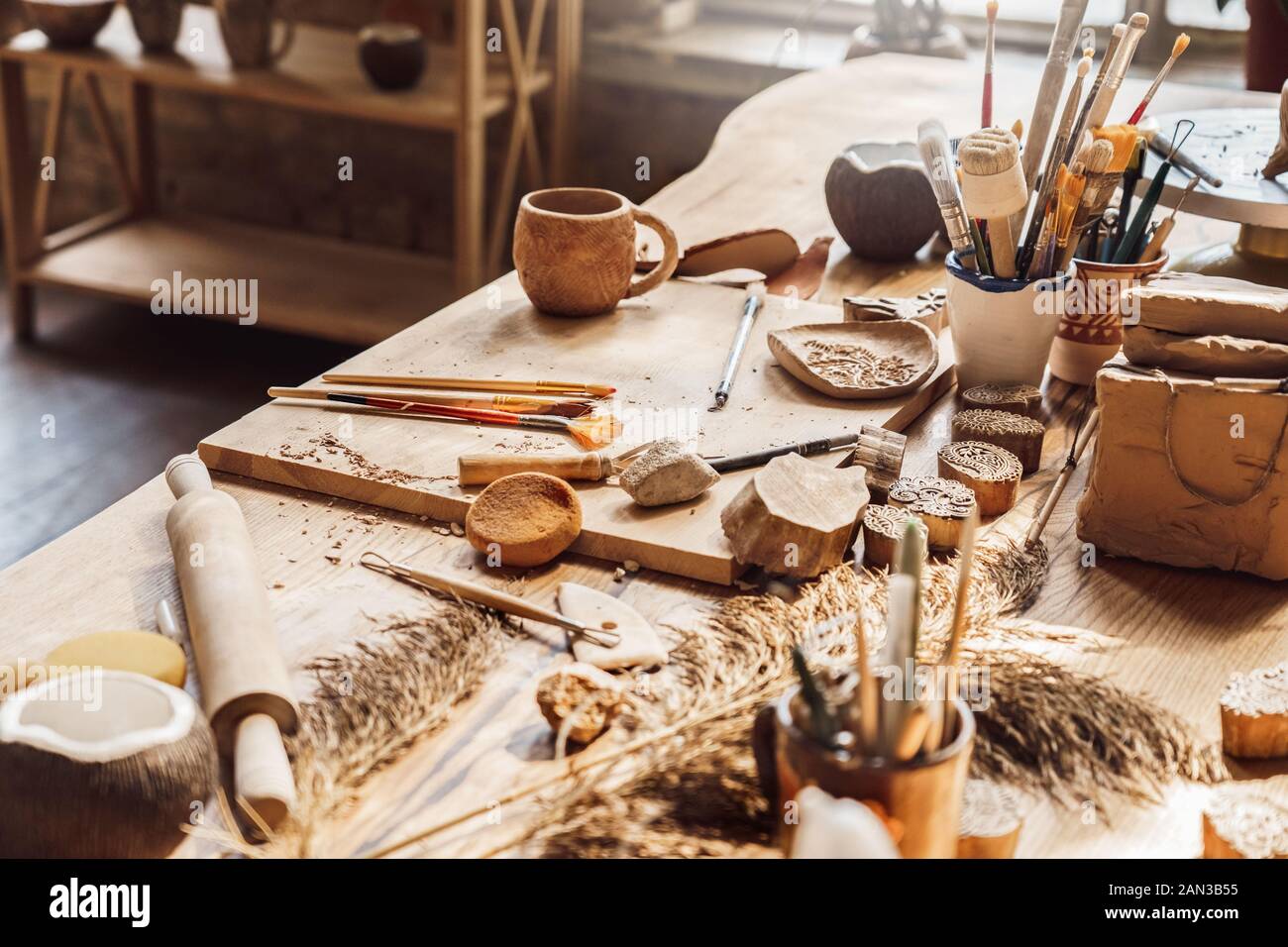 Craftsperson Workspace. Table with materials and tools for pottery ...