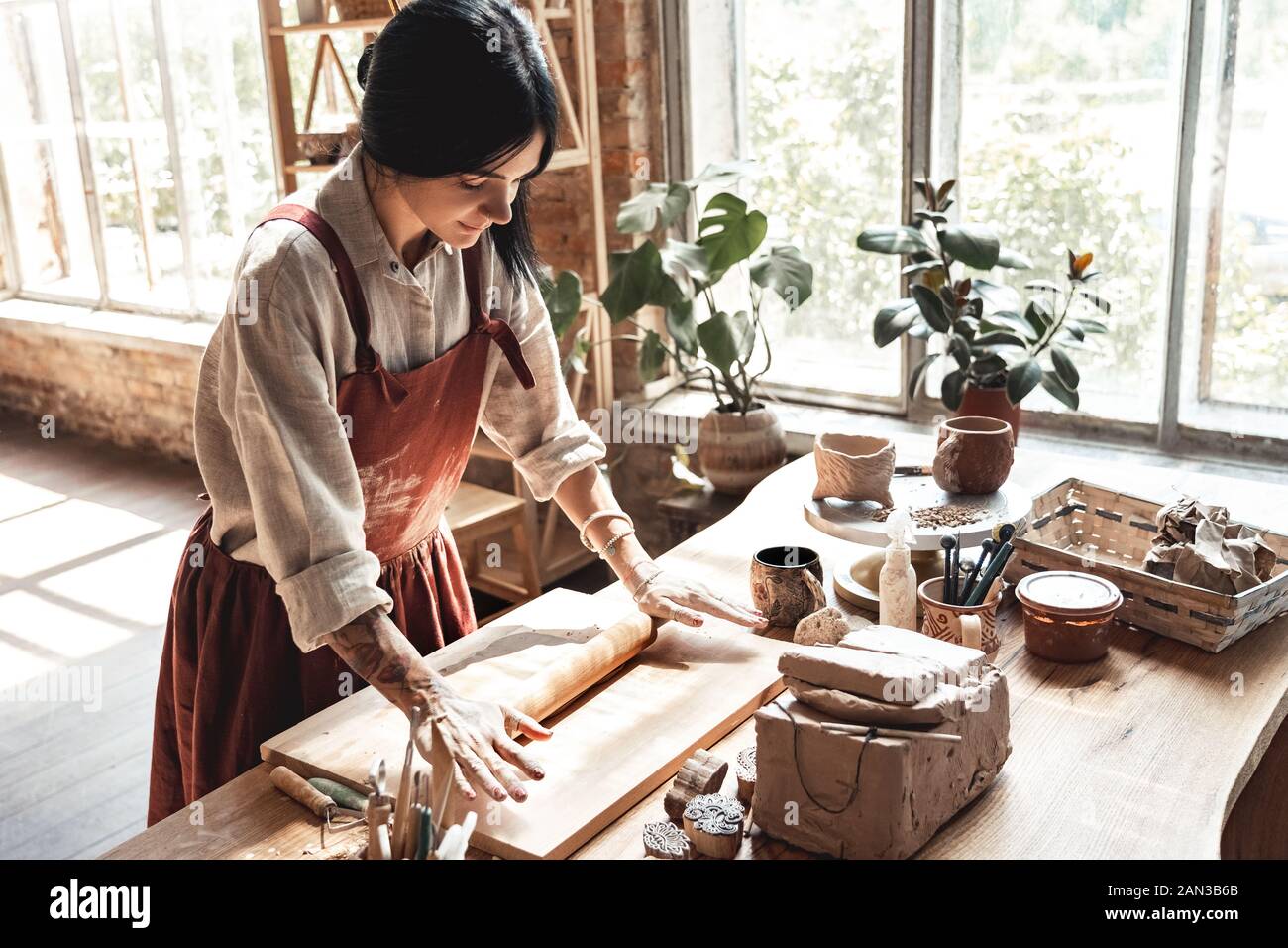Craftsperson Concept. Young woman making pottery at creative studio ...
