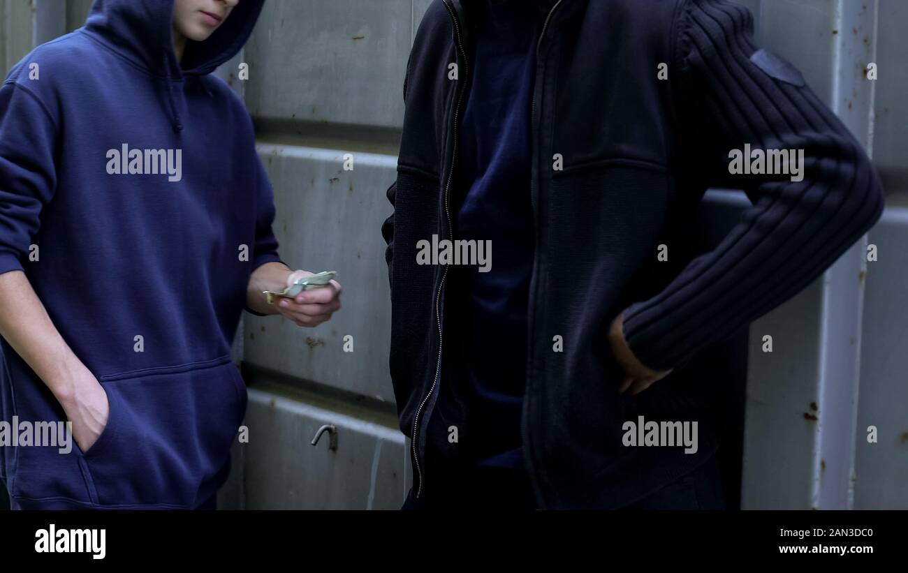 Addicted teenage boy buys pills from drug dealer, illegal trade ...