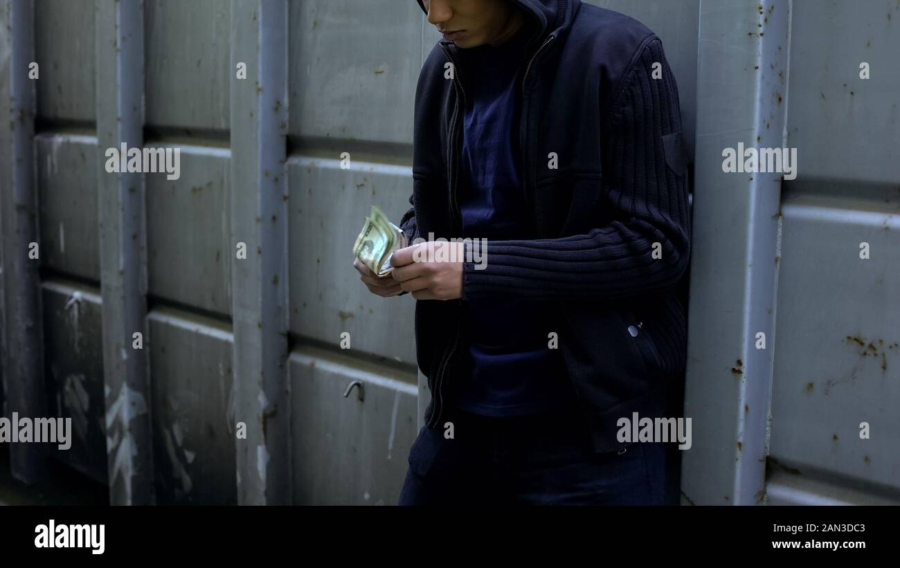 Mixed-race boy counting stolen money in backstreet, pickpocket ...