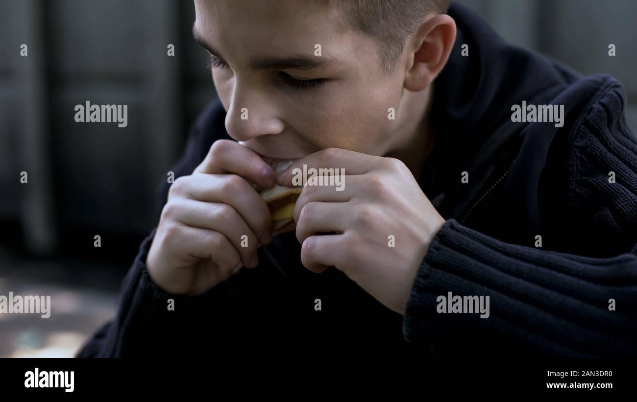 Beggar eating sandwich on street, social help for people in need ...