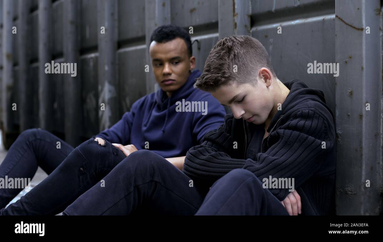 Elder guy encouraging his frightened friend, children of war, homeless ...