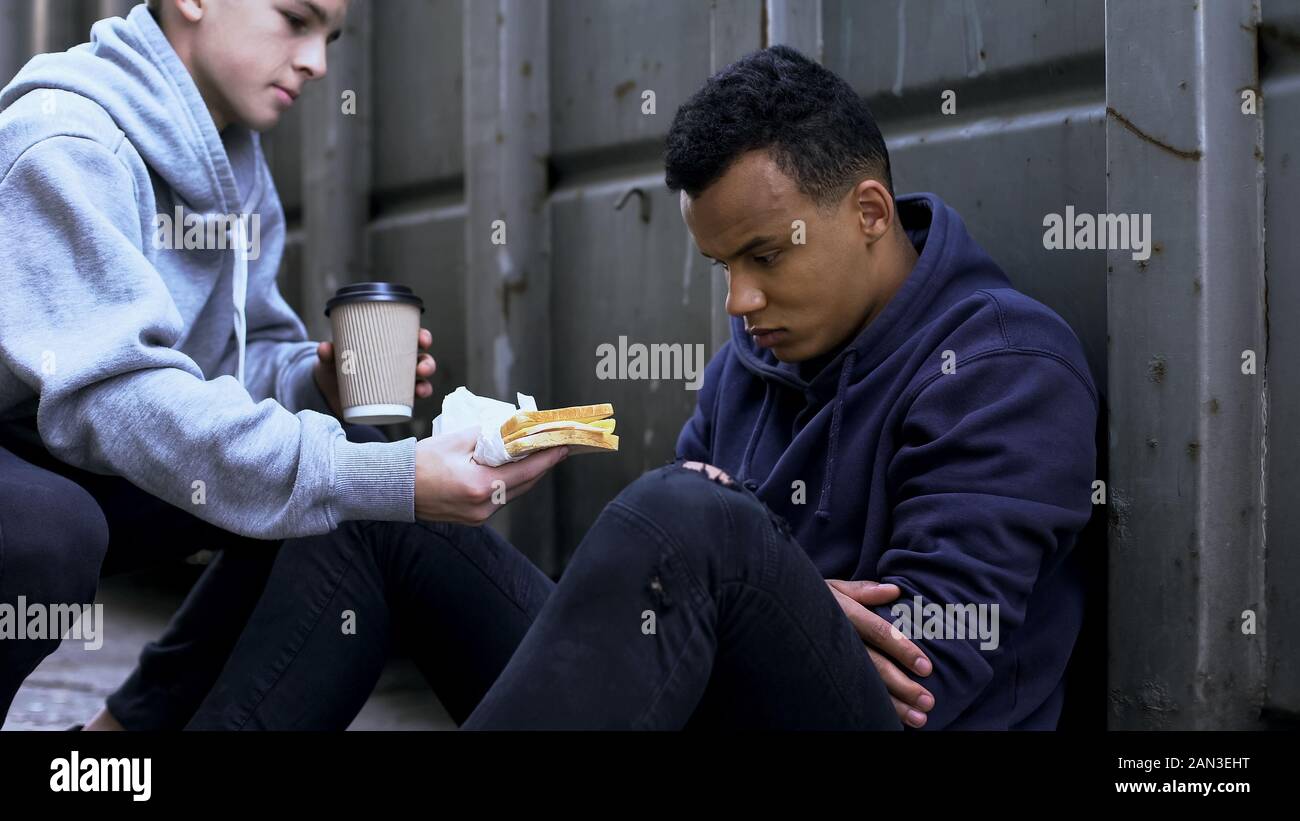 Caring volunteer boy brings dinner to homeless teenager, kind heart ...