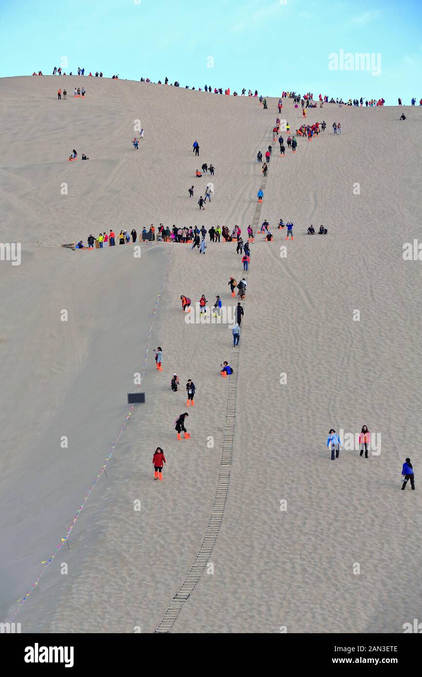 Sled-riders on the dunes around Crescent lake-Yueyaquan oasis. Dunhuang ...