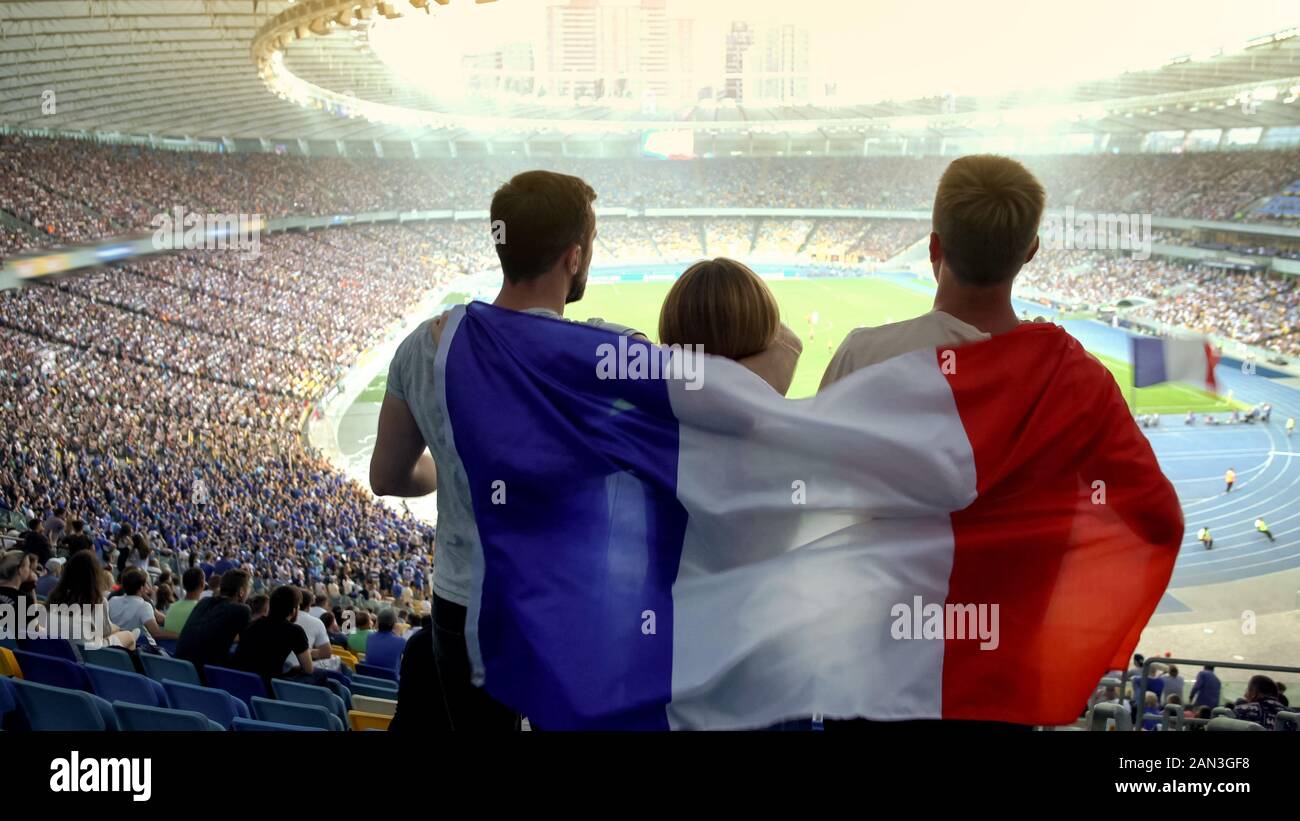 Football fans with French flag jumping at stadium, cheering for ...
