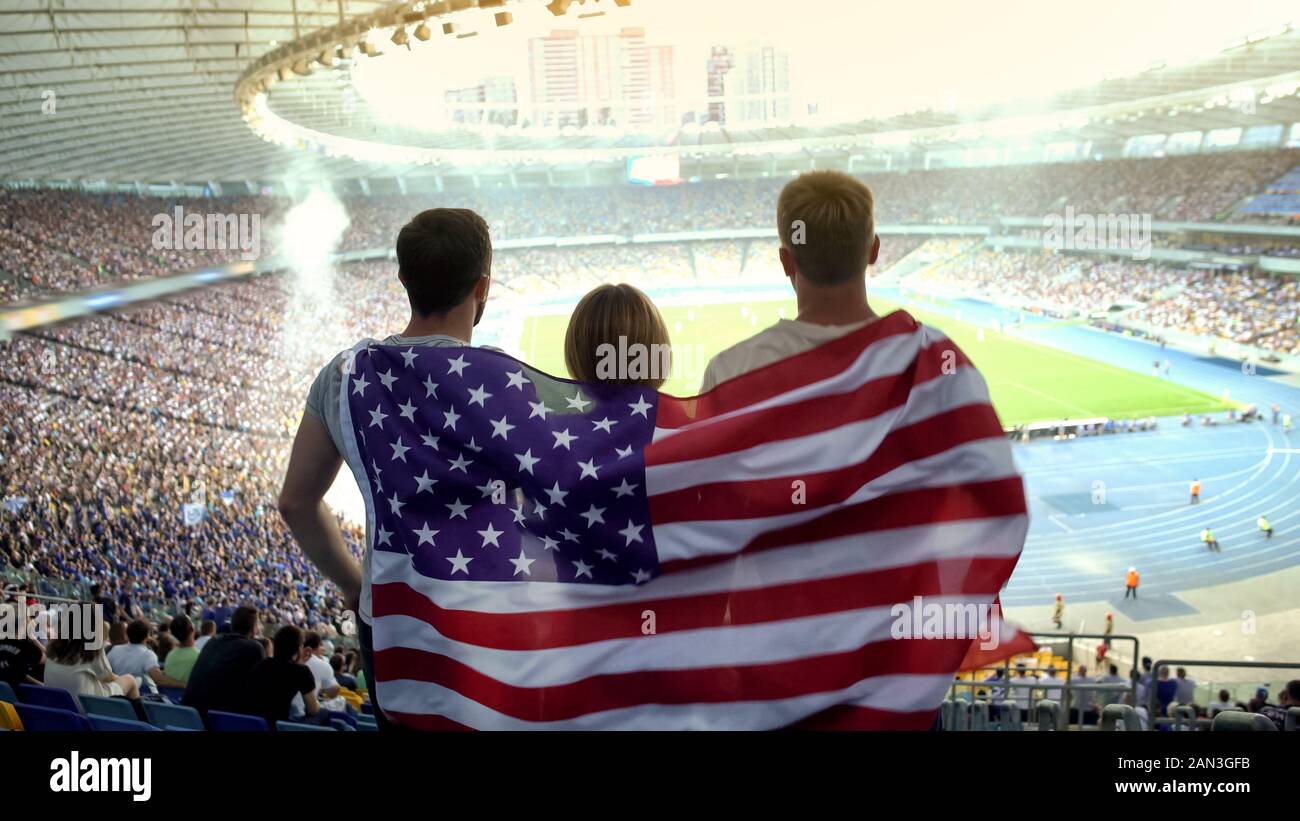 Football fans with American flag jumping at stadium, cheering for ...