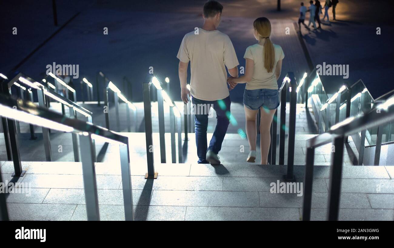 Young couple walking downstairs hi-res stock photography and images - Alamy