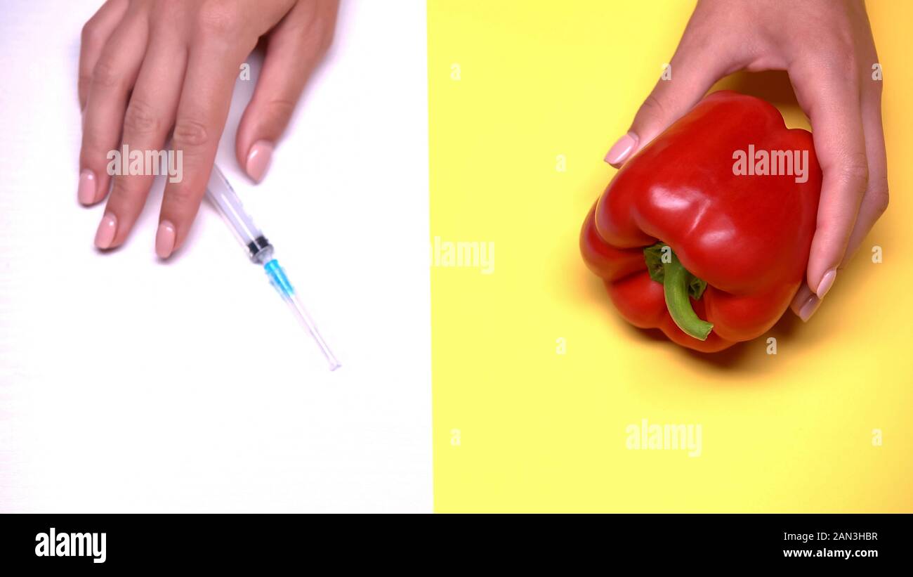 Genetically modified products, pepper and syringe macro shot, vegetable ...