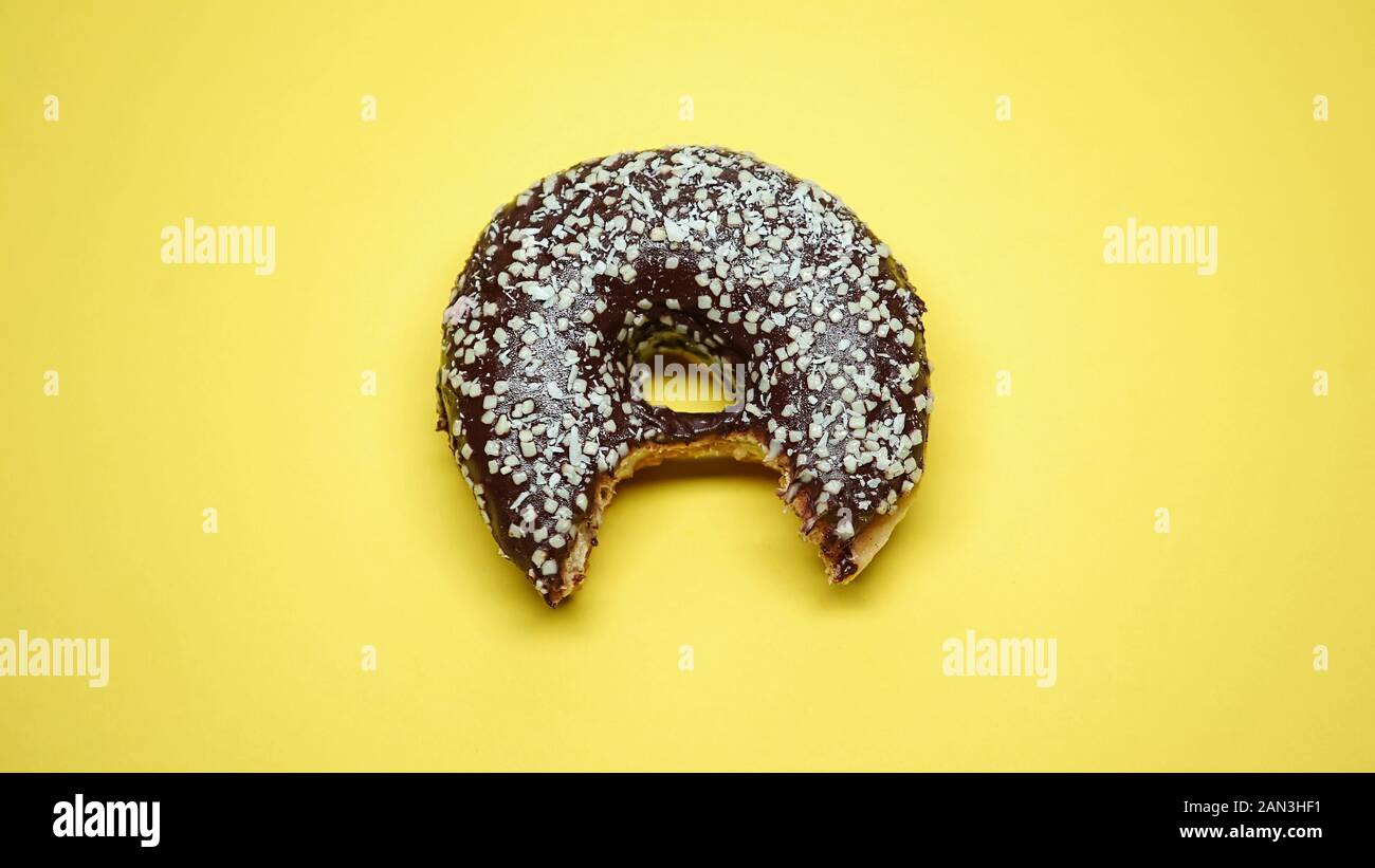 Bitten chocolate donut, junk food and unhealthy diet, overweight ...