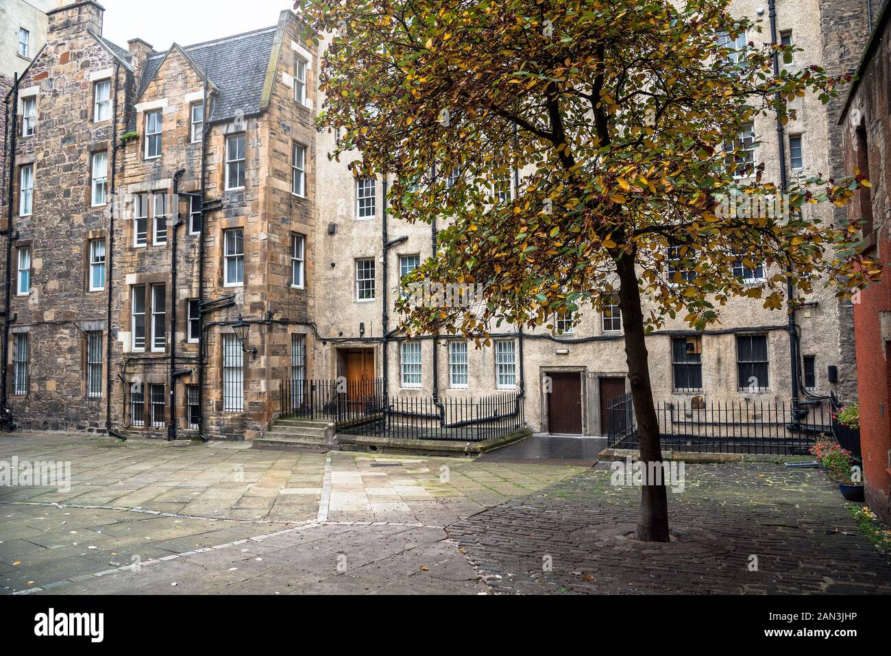 Old residential buildings around a cobblestone square with a colourful ...
