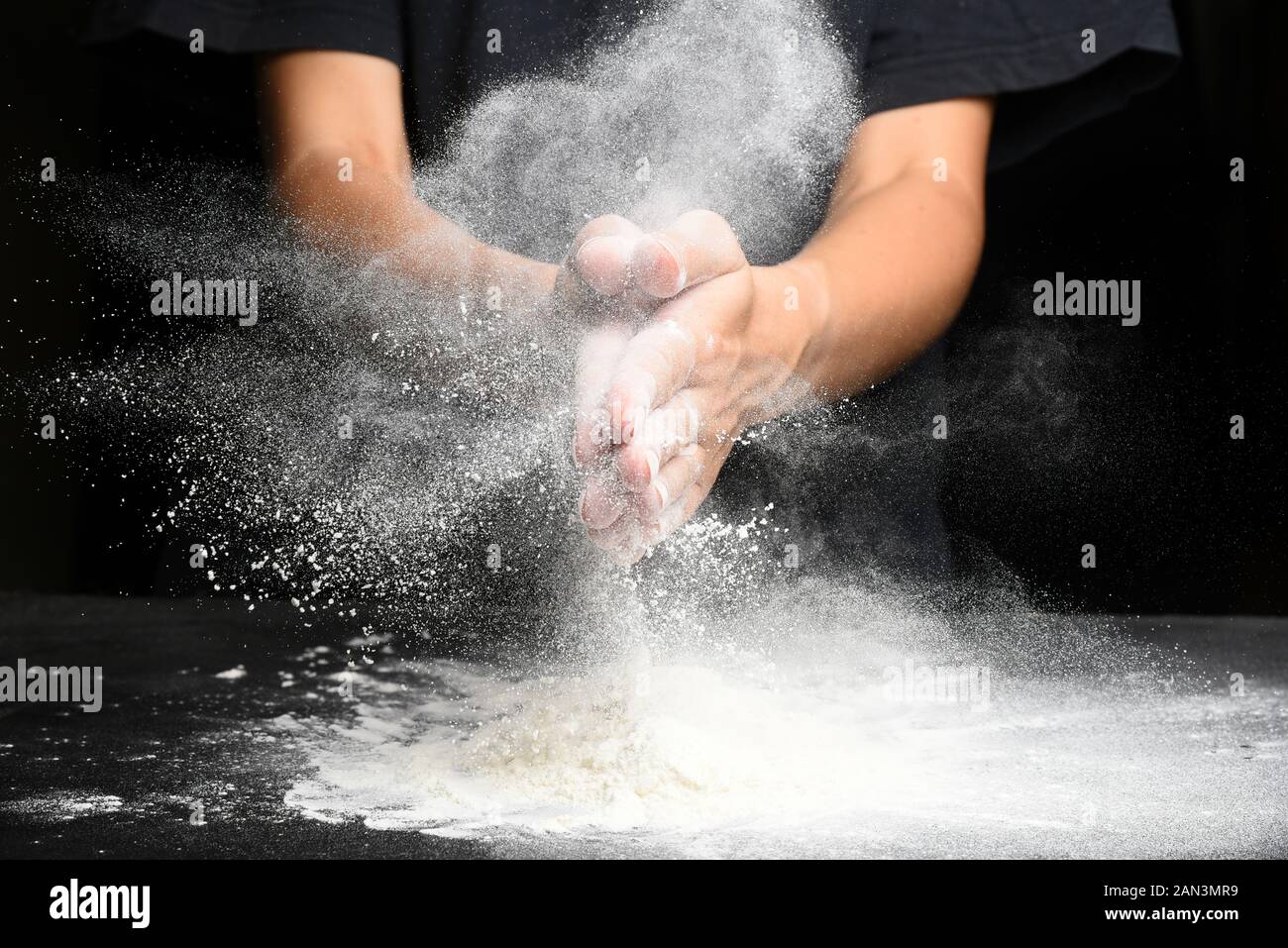 Cook's hands do is clapping with flour Stock Photo - Alamy