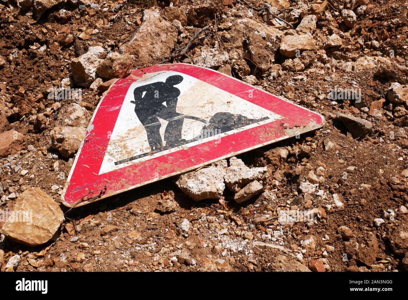 The road sign repair work lies on the ground. Old beaten and scratched ...