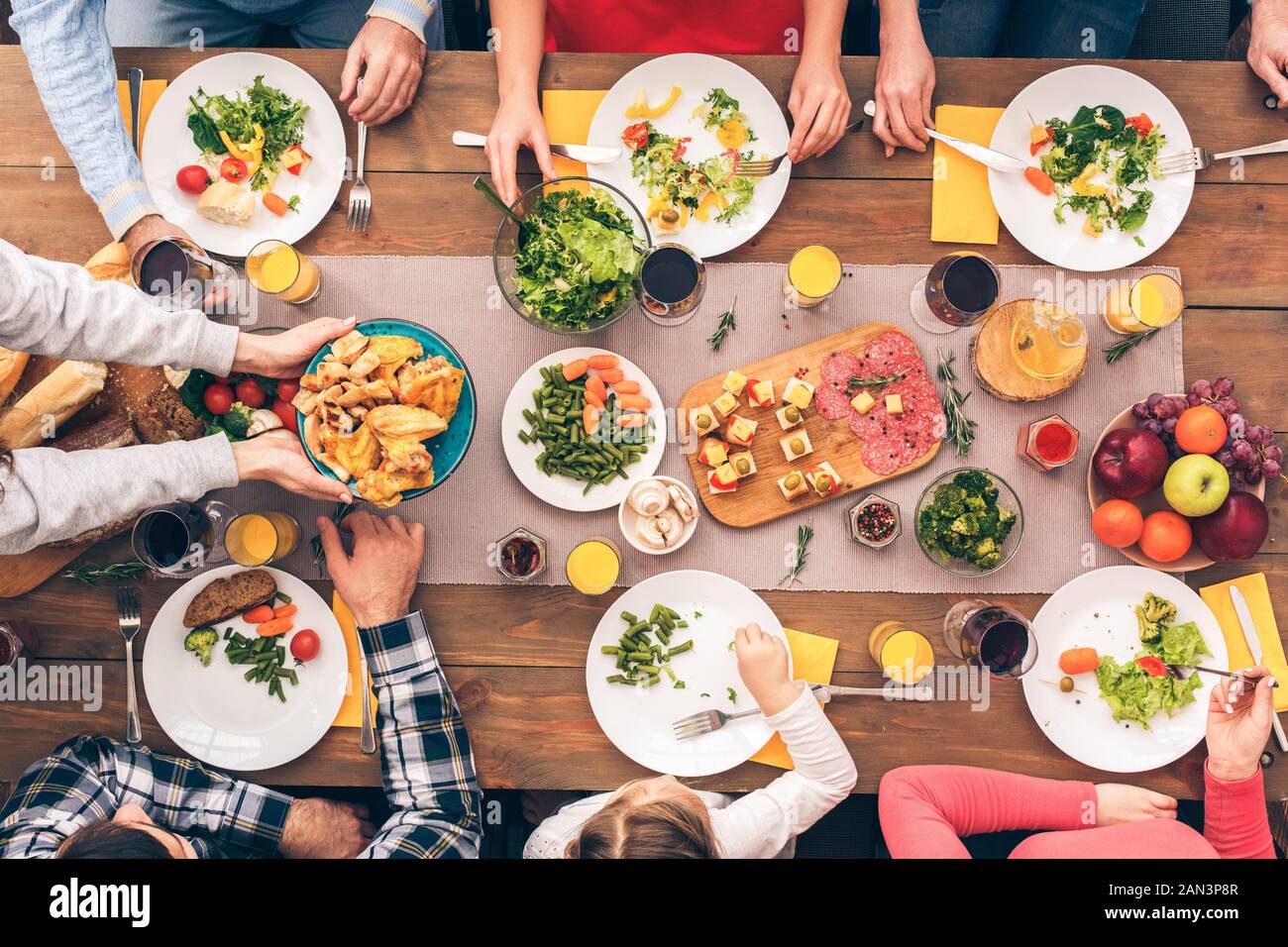Family sitting at home, eating food together Stock Photo - Alamy