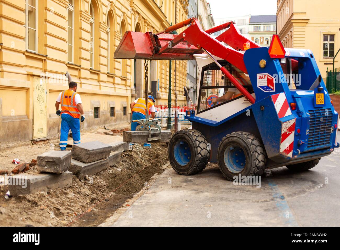 Replacement of curbs and repair of sidewalks in the old city. Workers ...