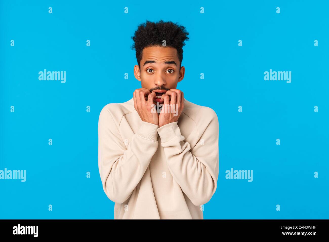 Scared timid and alarmed young trembling african american guy feeling ...