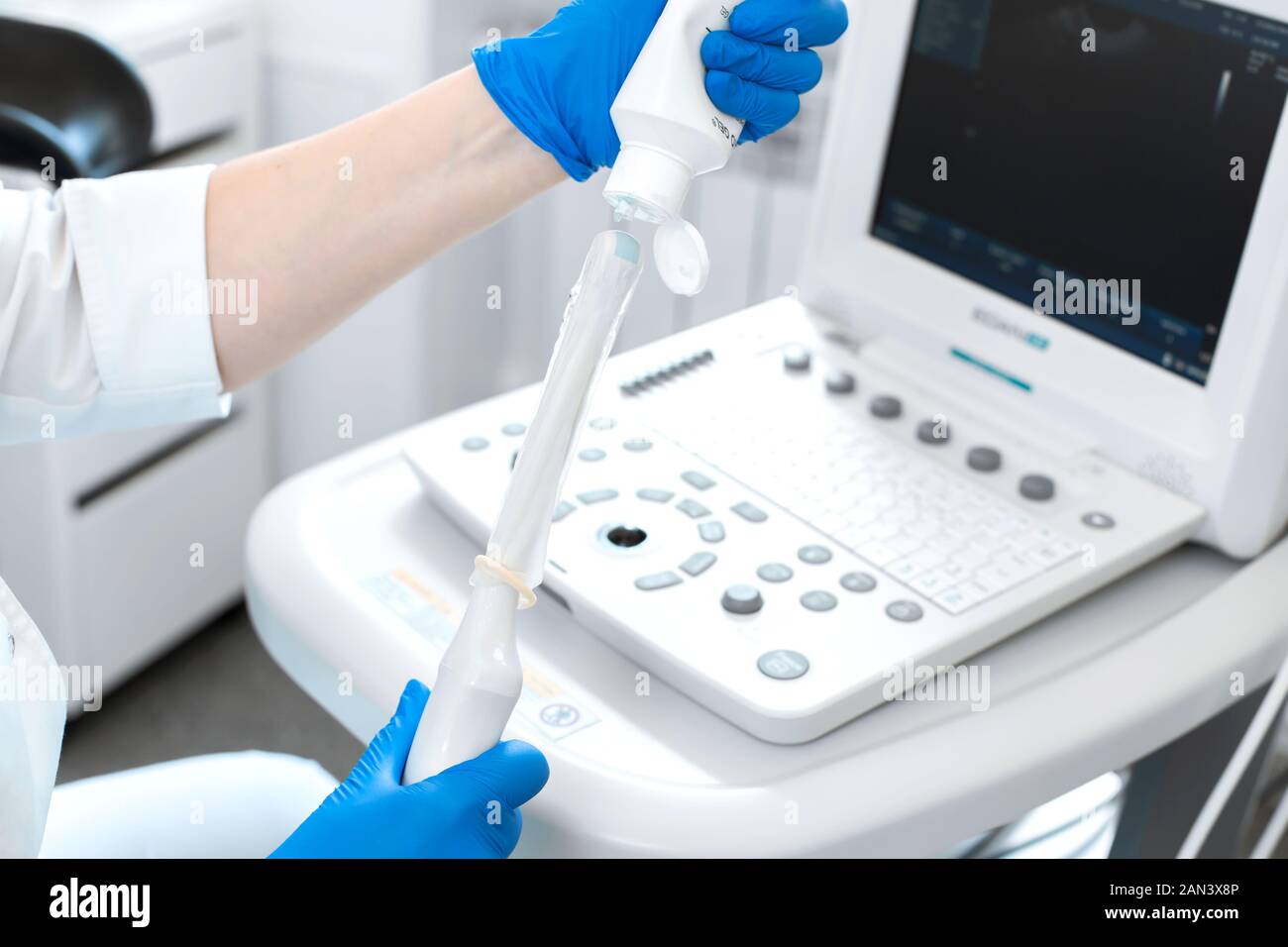 gynecologist doctor prepares an ultrasound machine for the diagnosis of ...