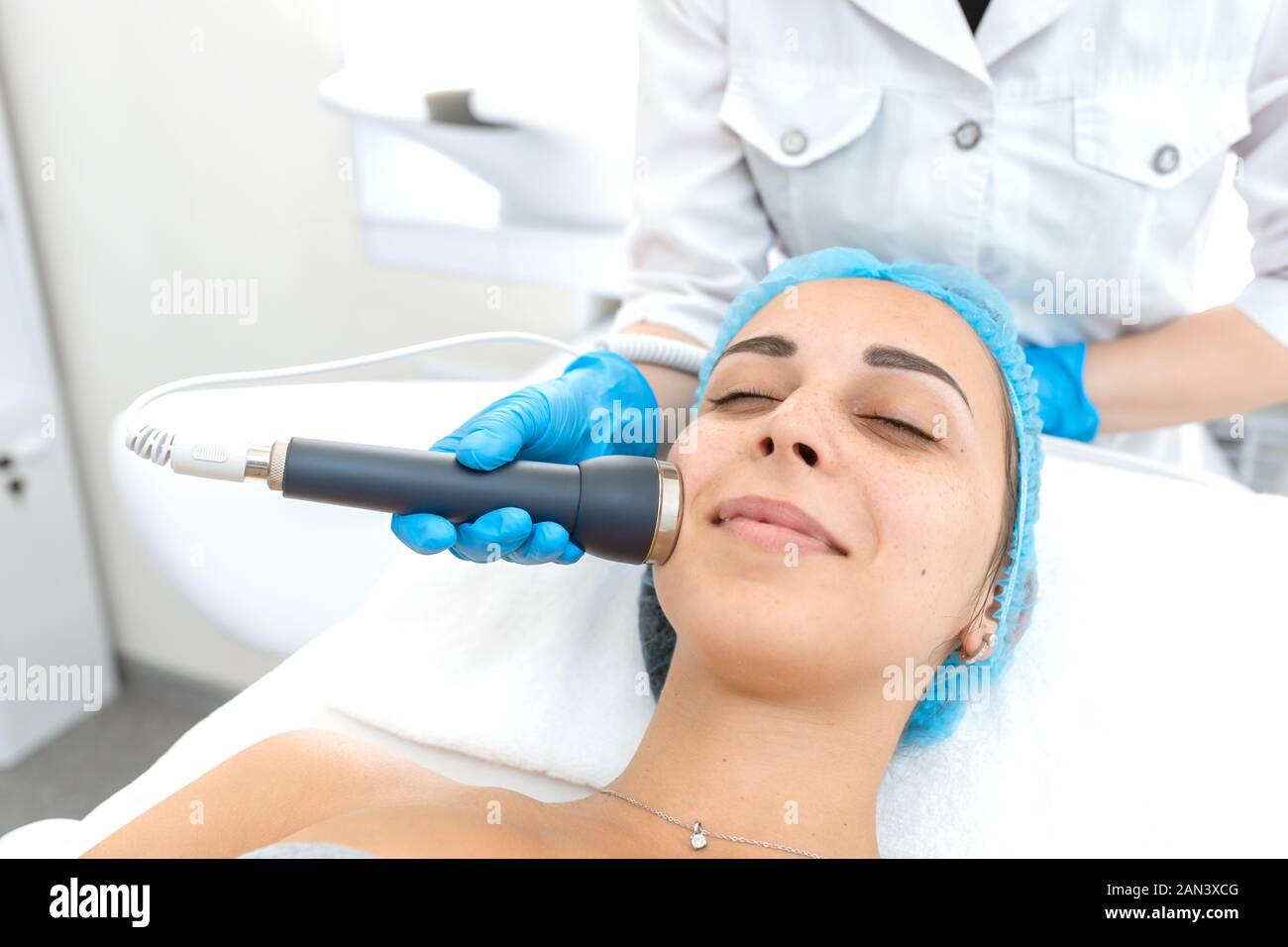 portrait of a young beautiful girl rf face lifting procedure. Face care ...