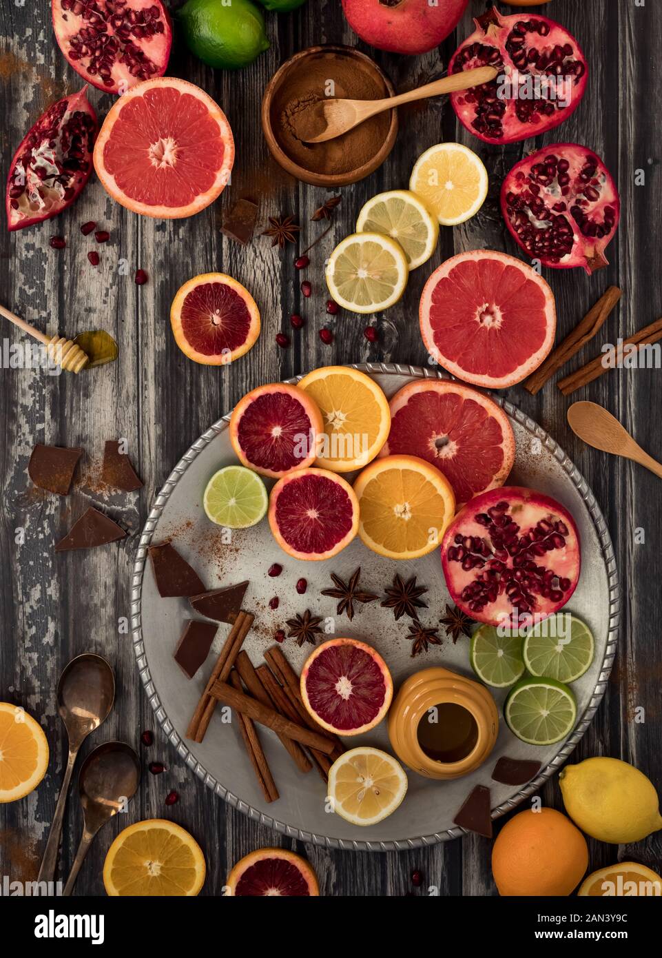Flat lay abstract collage of various citrus fruits along with cinnamon ...