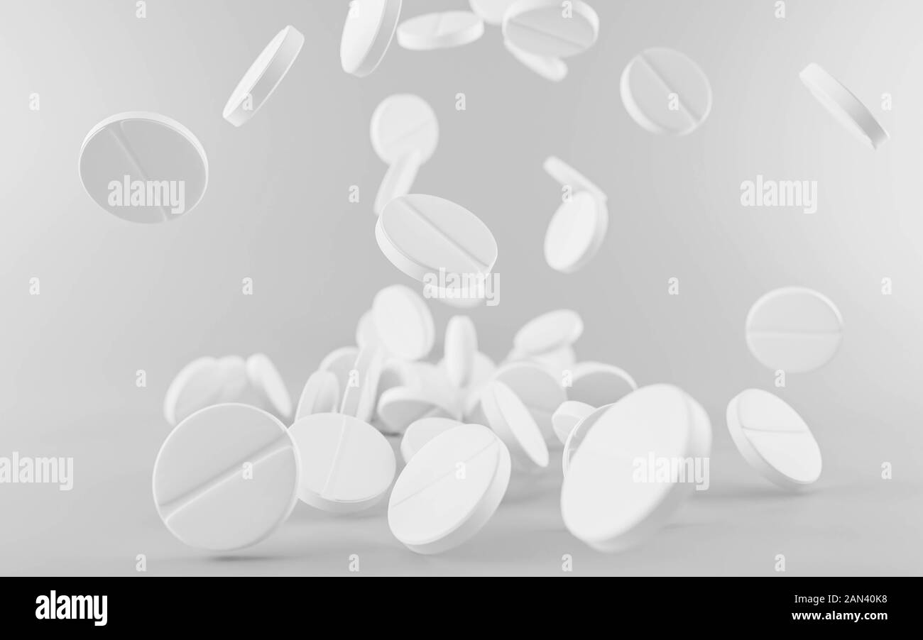 Many falling white pharma medication pills isolated on grey background ...