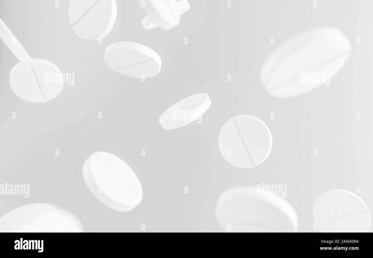 Many falling white pharma medication pills isolated on grey background ...