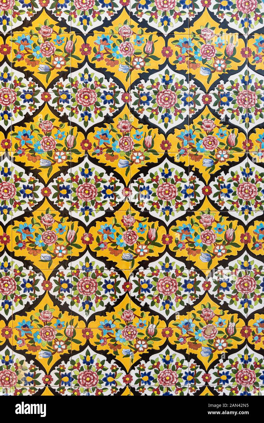 Yellow ceramic tile decorations in floral patterns with Islamic Iranian ...