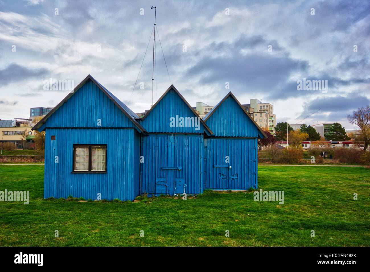 three Beach huts standing next each other under cloudy afternoon by ...