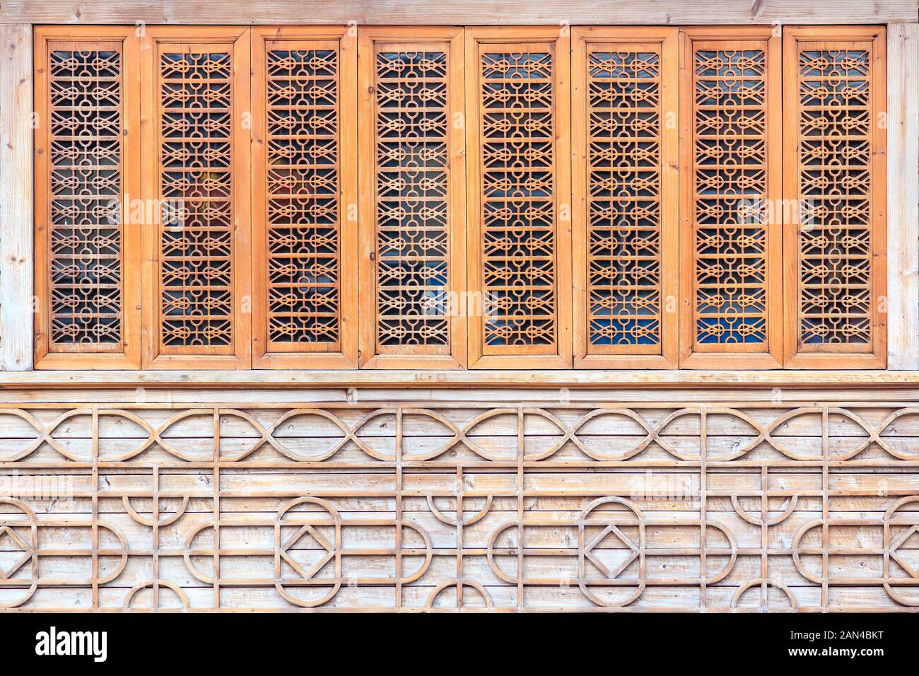 The traditional wooden wall with lattice windows and outside decoration ...