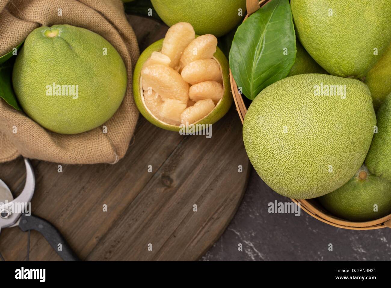Fresh peeled pomelo, pummelo, grapefruit, shaddock on dark background ...