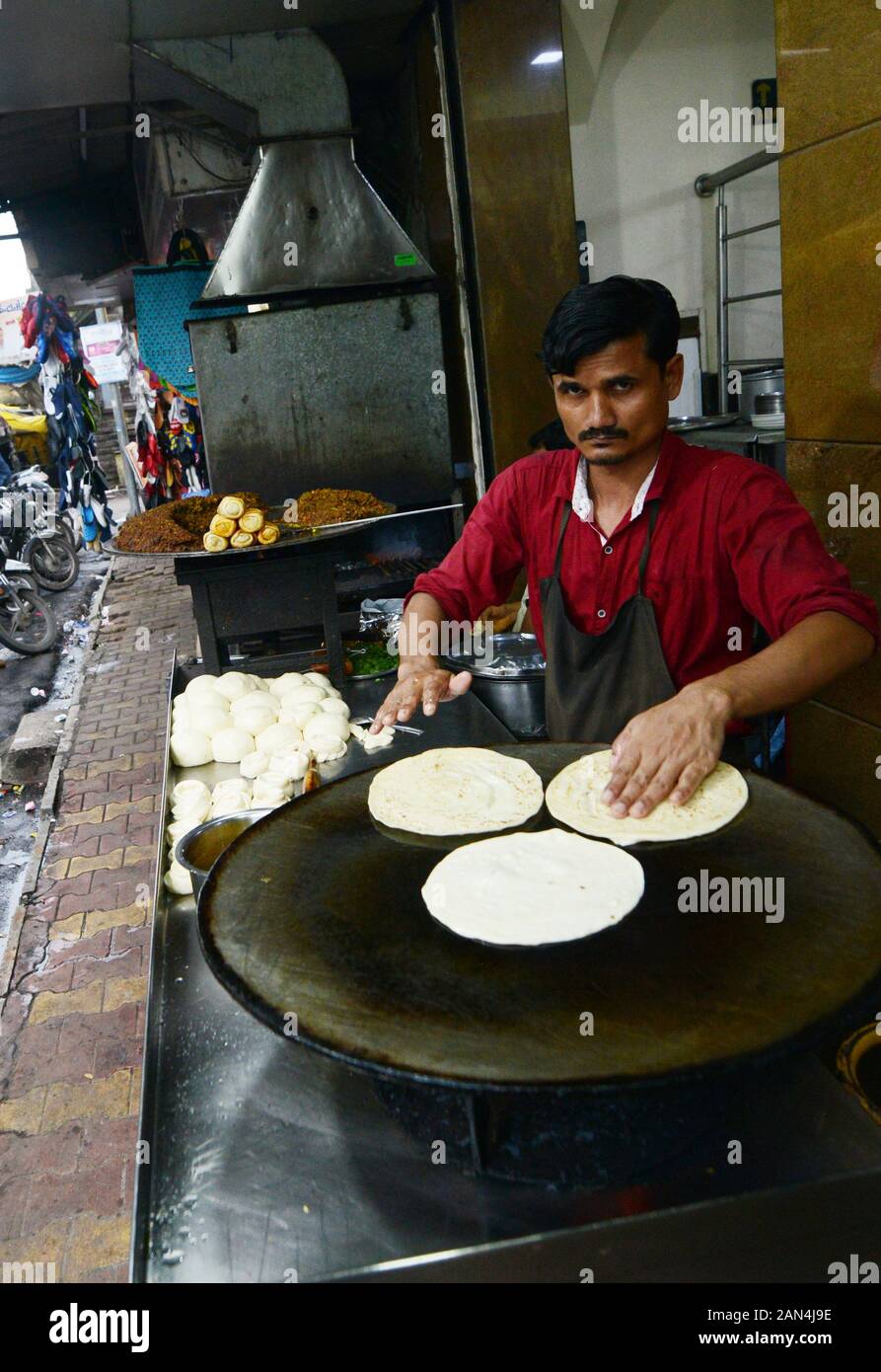An Indian man making chapatis Stock Photo - Alamy