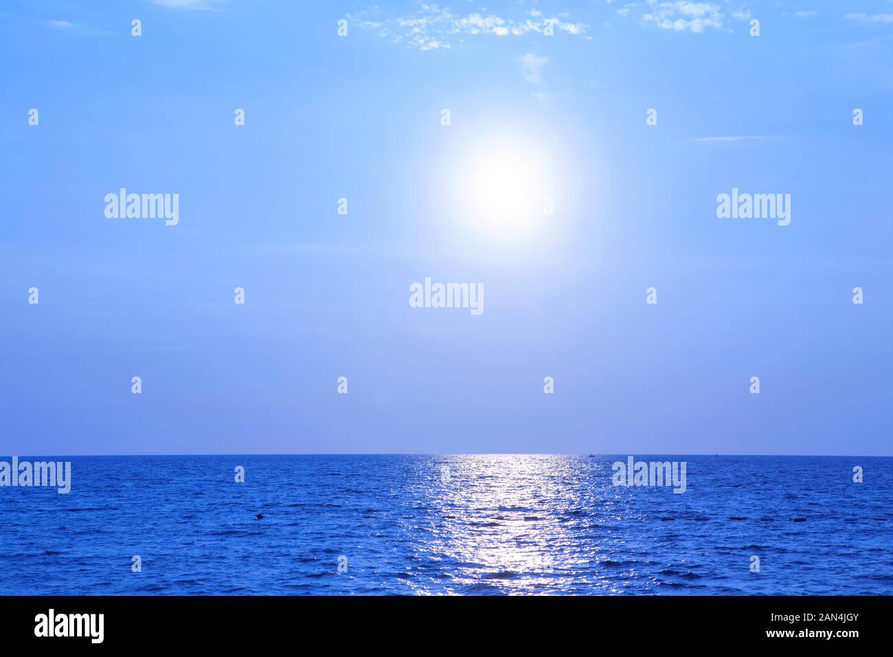 marine scenery with sun over blue sea Stock Photo - Alamy