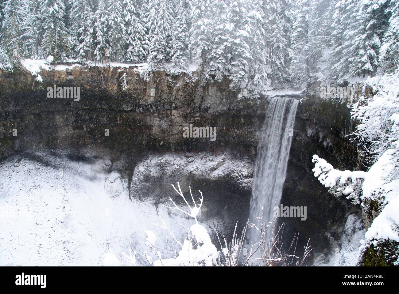 Brandywine waterfall in a winter snowy forest landscape, with natural ...