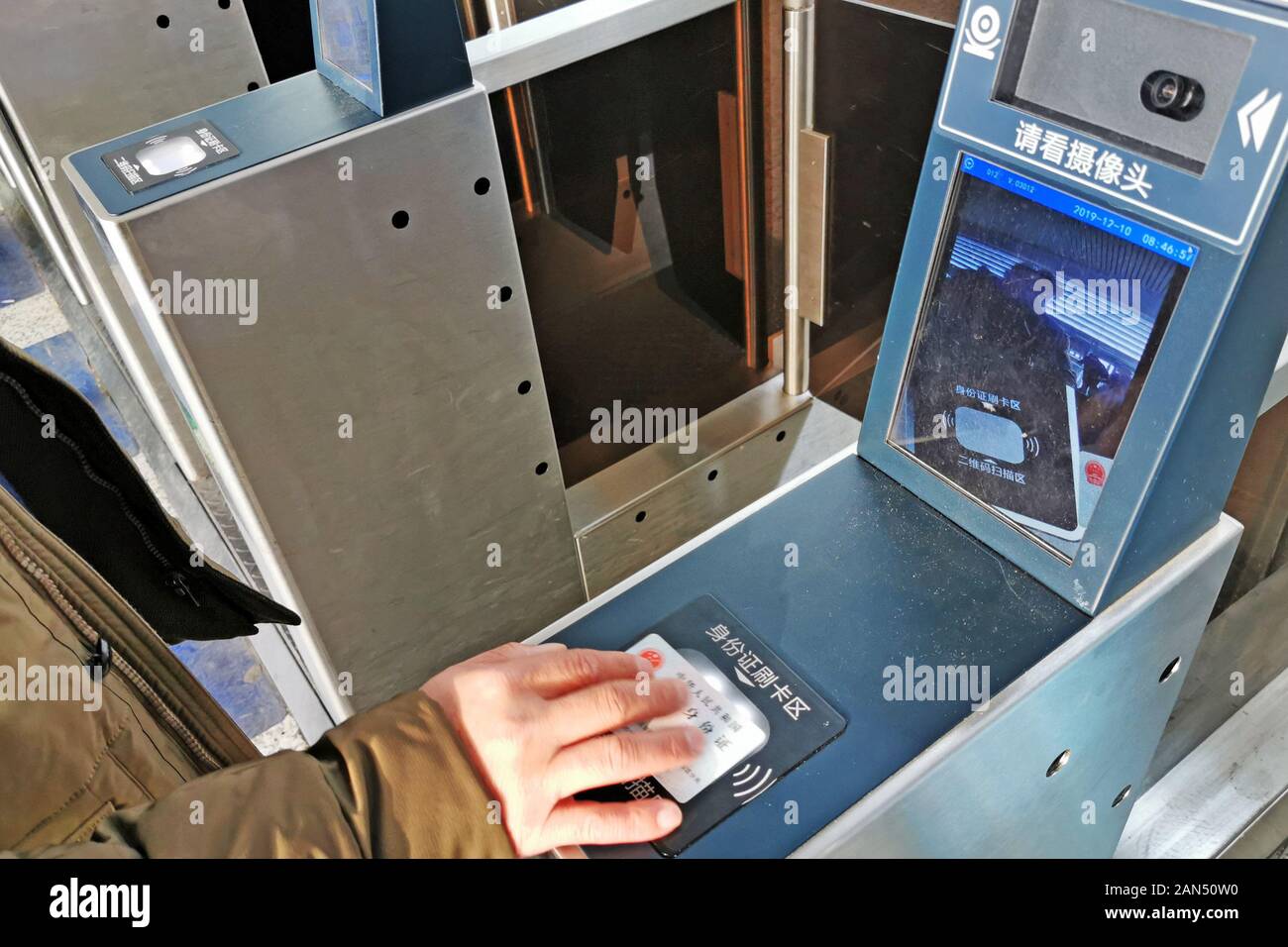 Passengers use ID card instead of paper ticket to board the train at ...