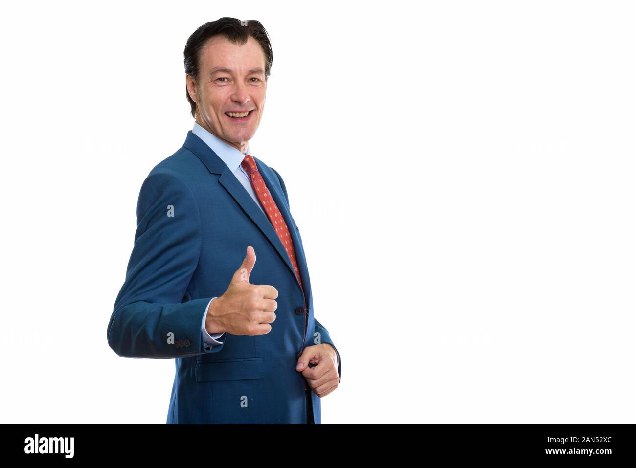Studio shot of mature happy businessman giving thumbs up Stock Photo ...