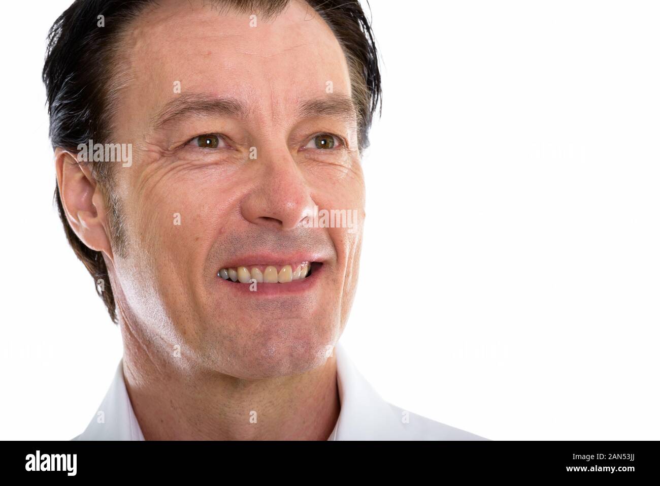 Close up of happy mature handsome man smiling while thinking Stock ...