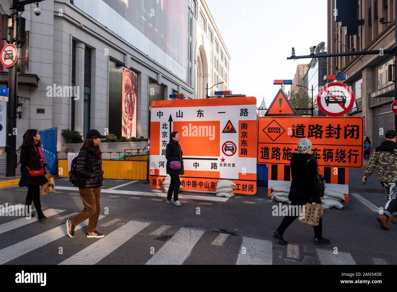 Signs and roadblocks are deployed to stop traffic near Nanjing Road as ...