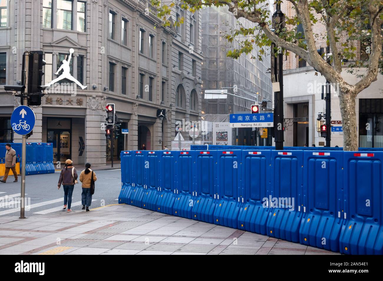Signs and roadblocks are deployed to stop traffic near Nanjing Road as ...