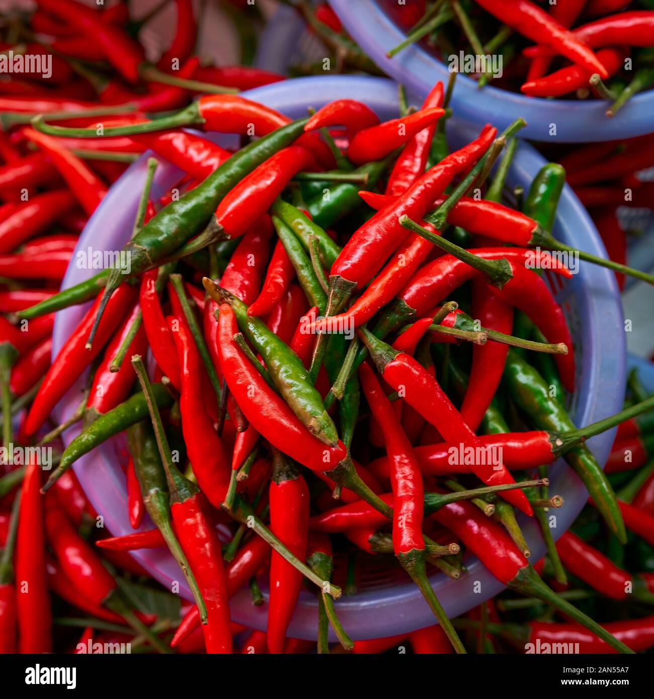 Fresh red chili peppers offered at a stall on a food market in Bangkok ...